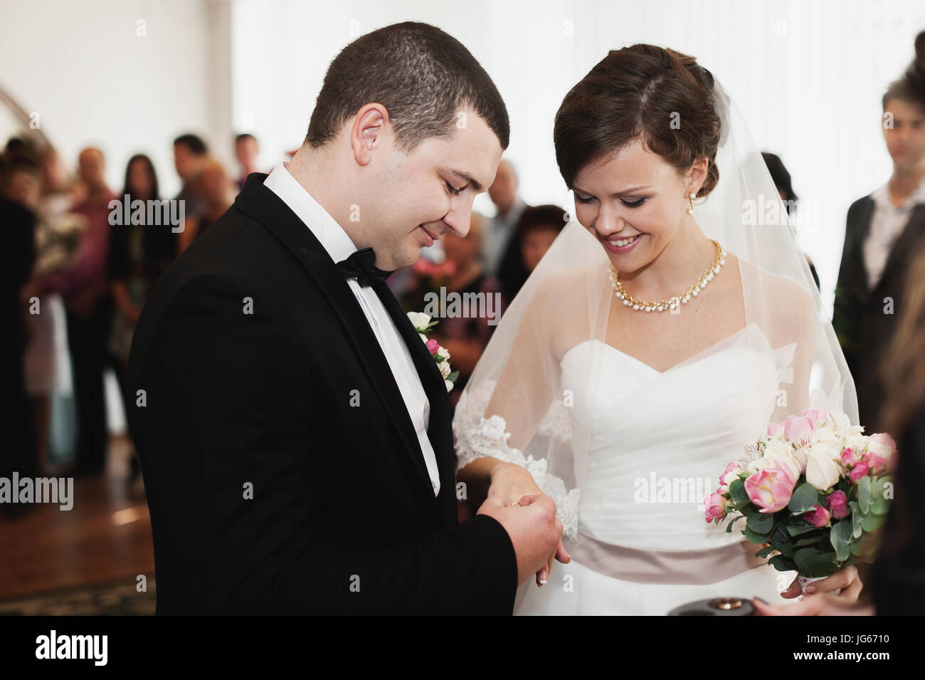 Bride and groom on marriage registration. The groom looks at the bride ...