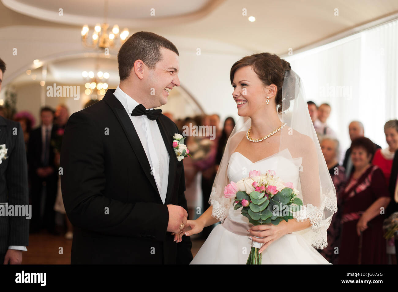 Bride and groom on marriage registration. The groom looks at the bride ...
