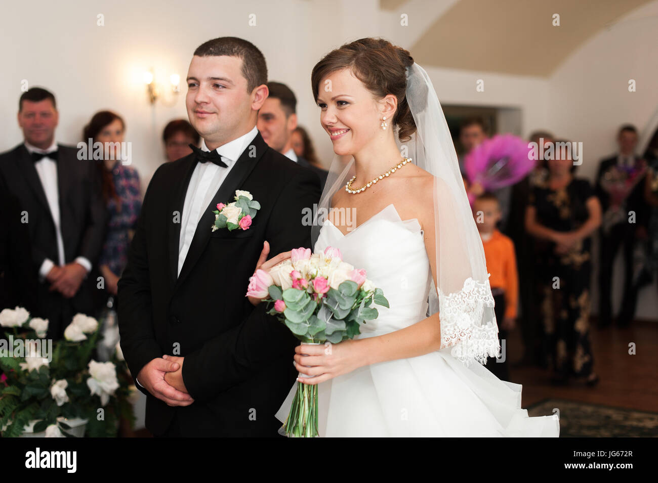 Bride and groom on marriage registration. The groom looks at the bride ...
