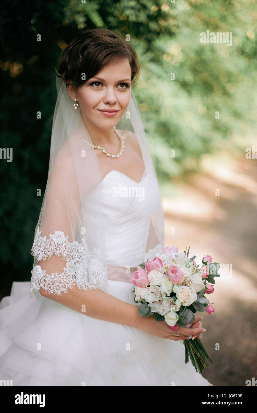Beautiful bride woman portrait with bridal bouquet posing in her ...