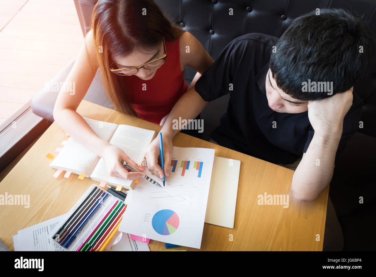 couple of students in a classroom doing homework Stock Photo - Alamy