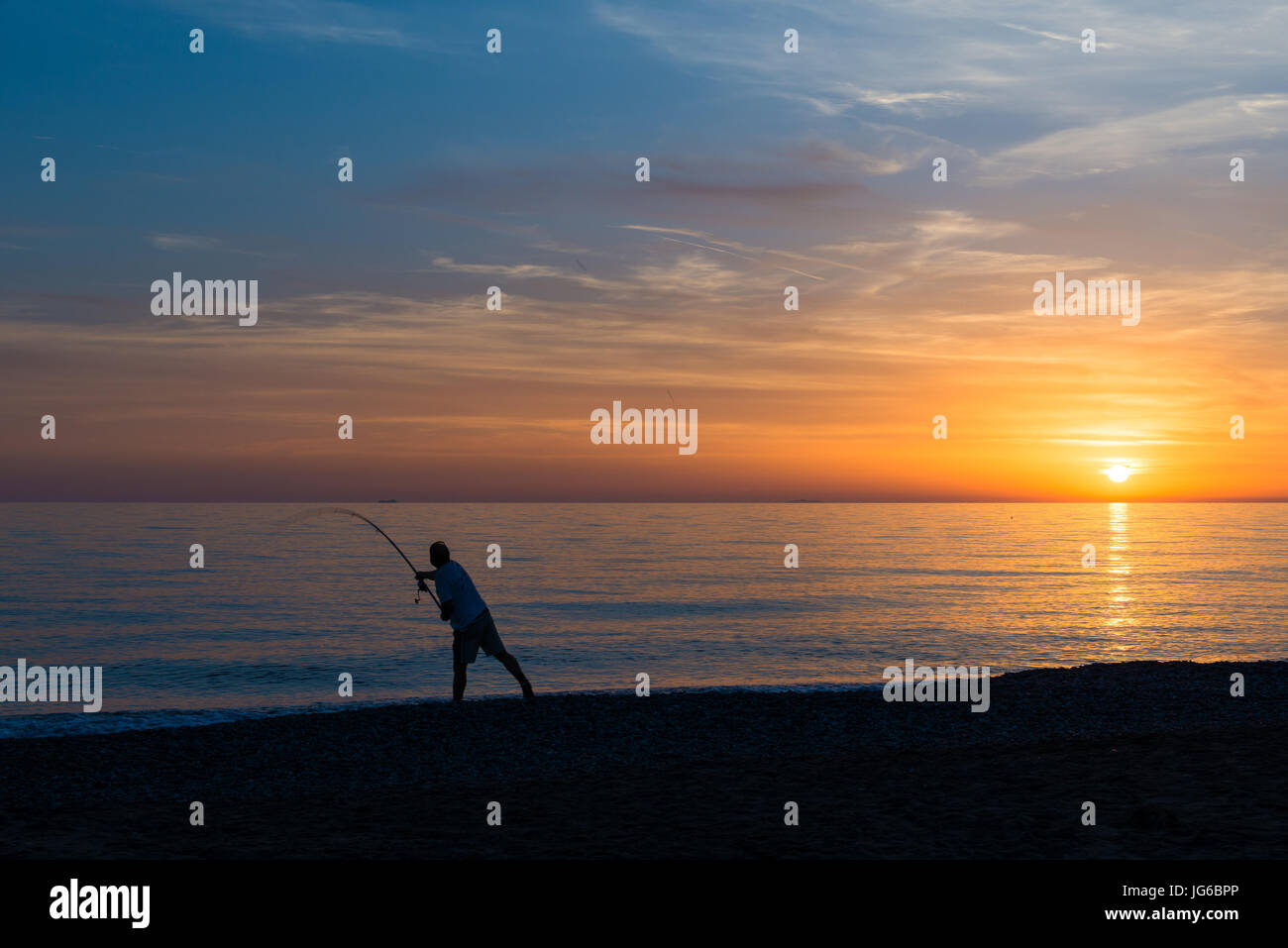 Fisherman with fishing rod makes the launch in the sea Stock Photo - Alamy