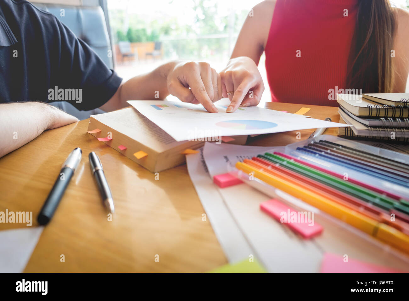 students studying and learning in a coffee shop with a laptop and notes ...