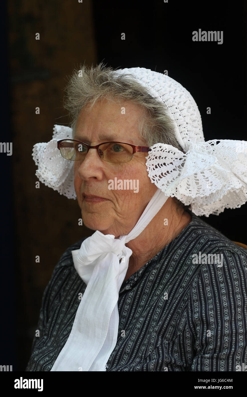 Senior women wearing traditional Dutch caps or bonnets made of white ...