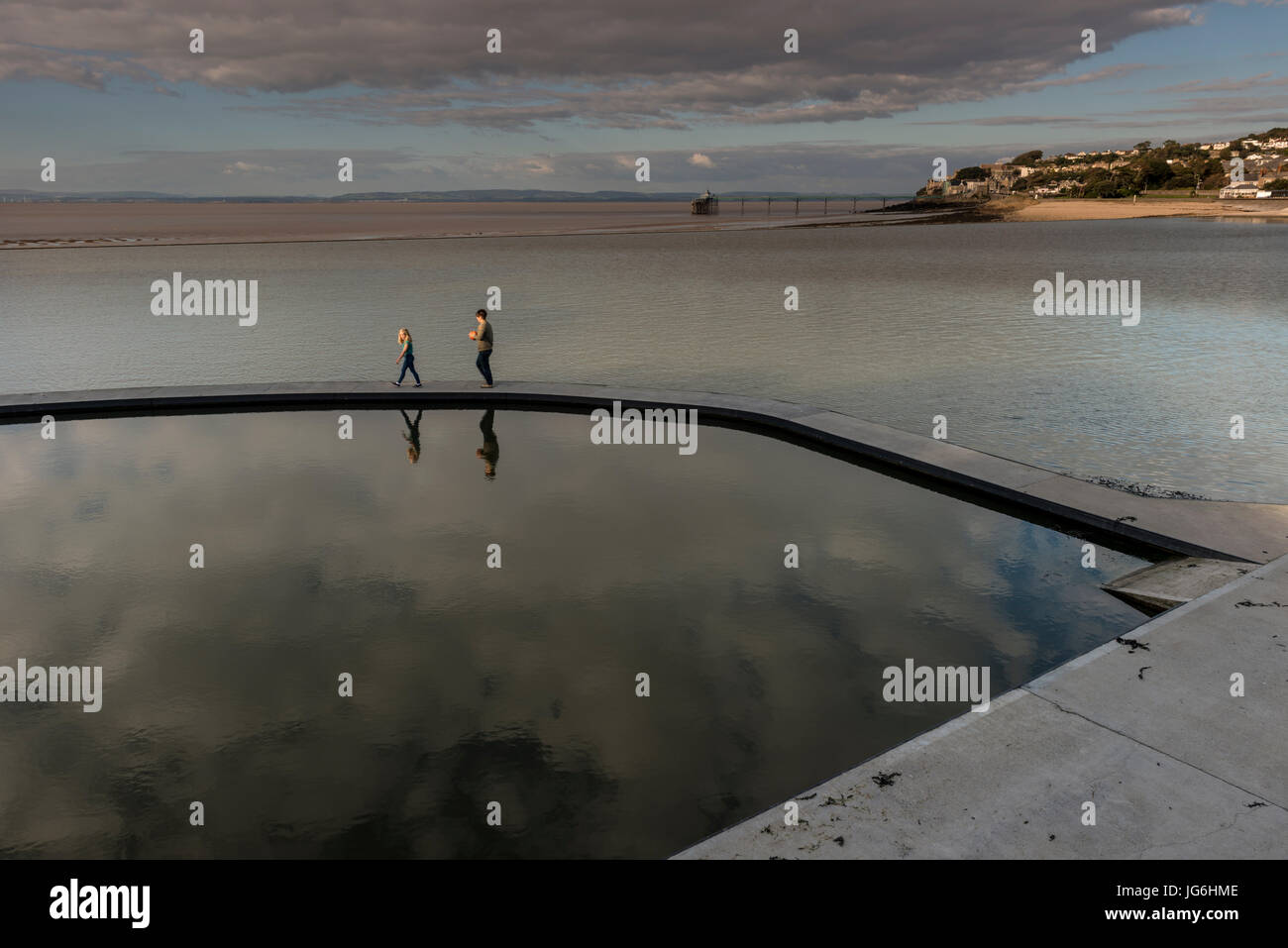 A mother and a child walking along the edge of Marine Lake (seawater ...