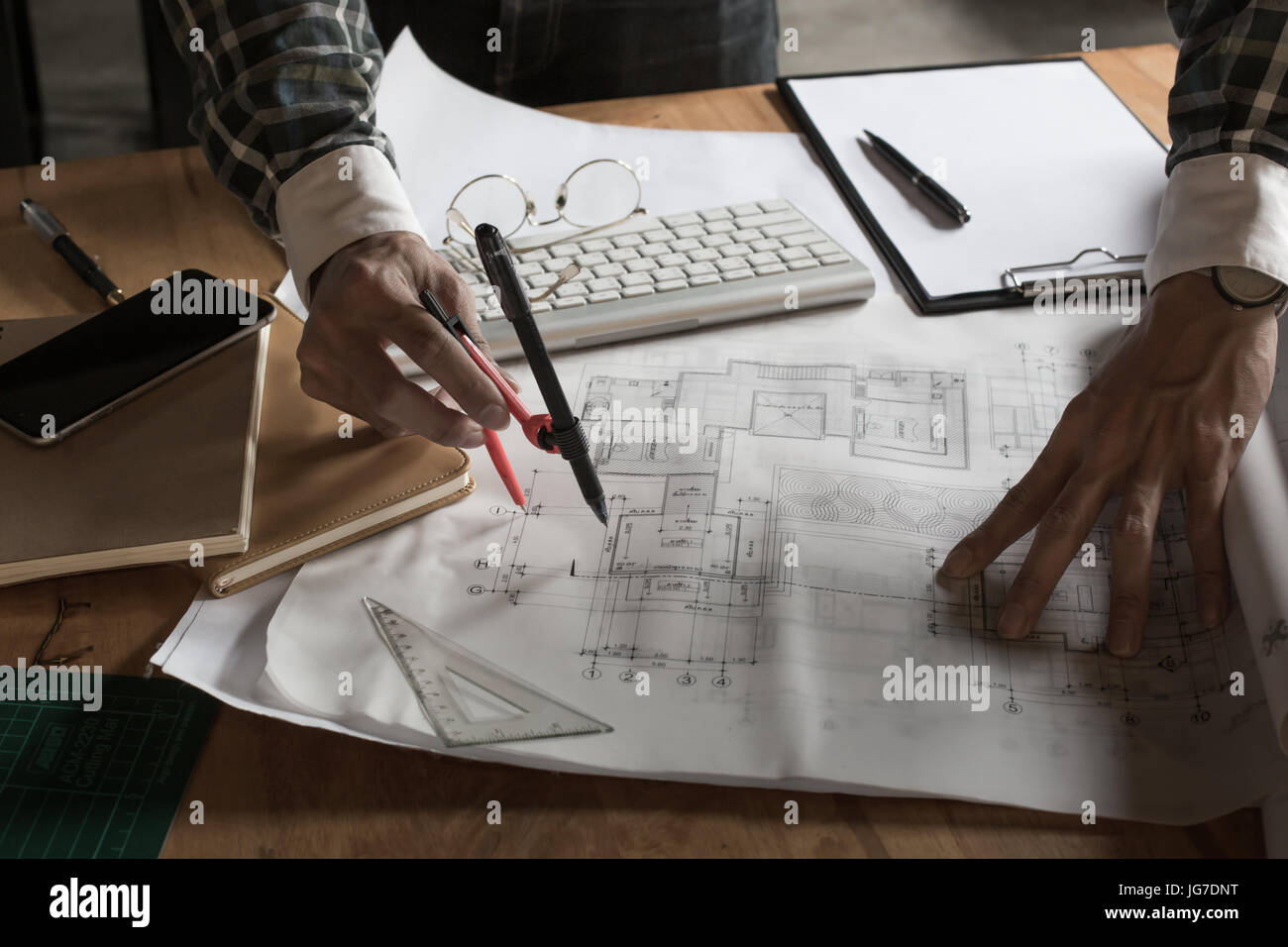 Creative architect projecting on the big drawings in the dark loft ...