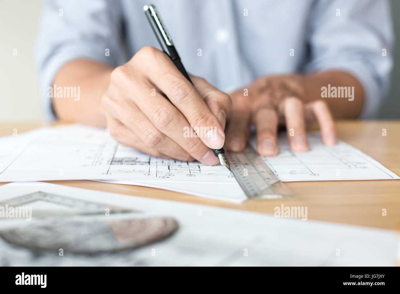 Creative architect projecting on the big drawings in the dark loft ...