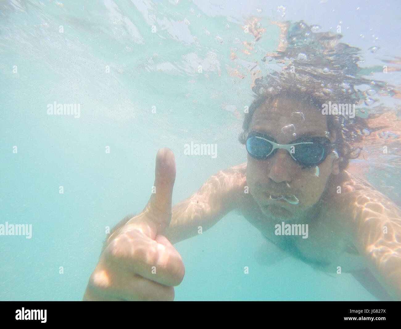 Underwater view of man swimming in the sea Stock Photo - Alamy