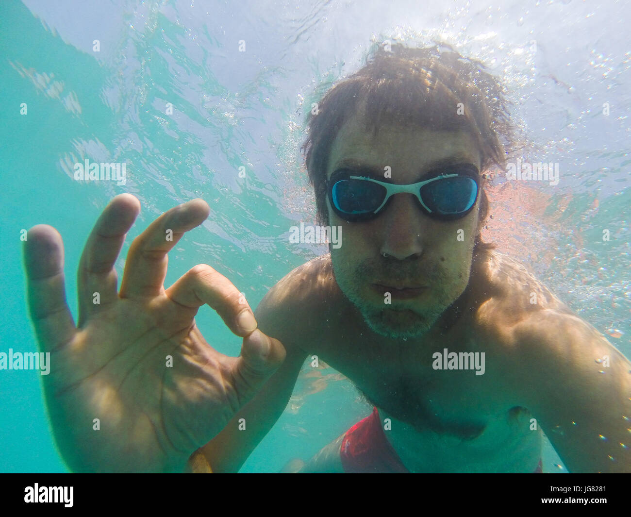 Underwater view of man swimming in the sea Stock Photo - Alamy