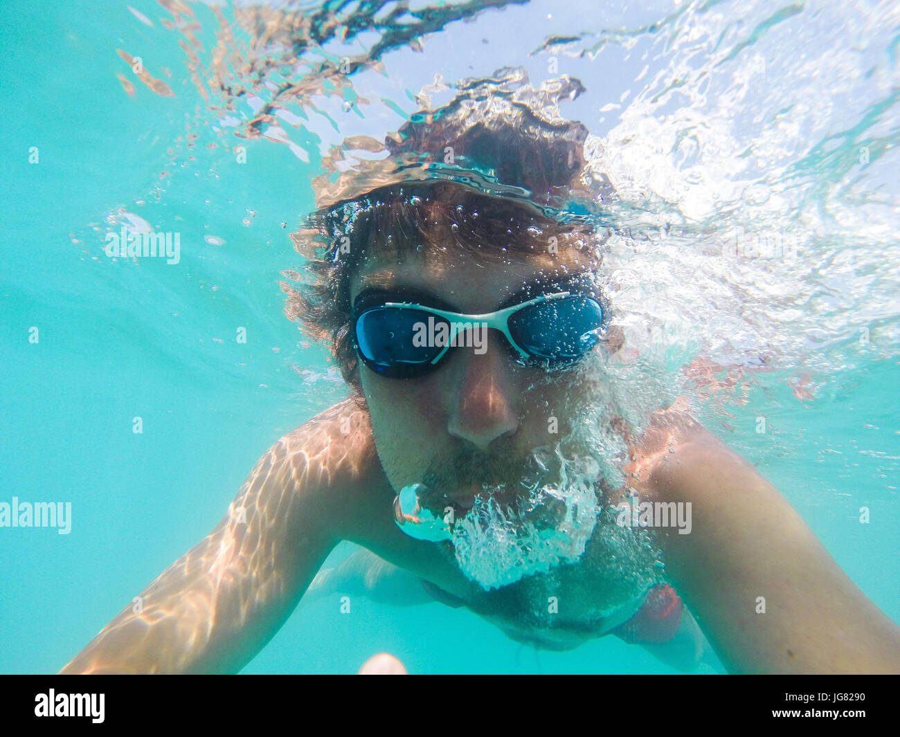 Underwater view of man swimming in the sea Stock Photo - Alamy