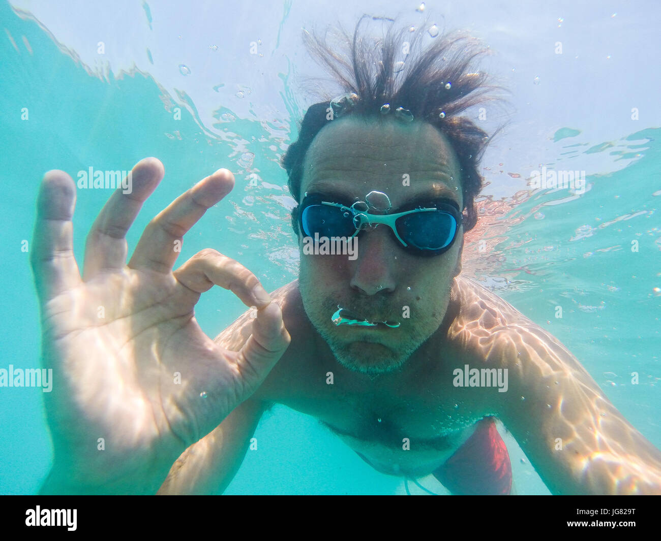 Underwater view of man swimming in the sea Stock Photo - Alamy