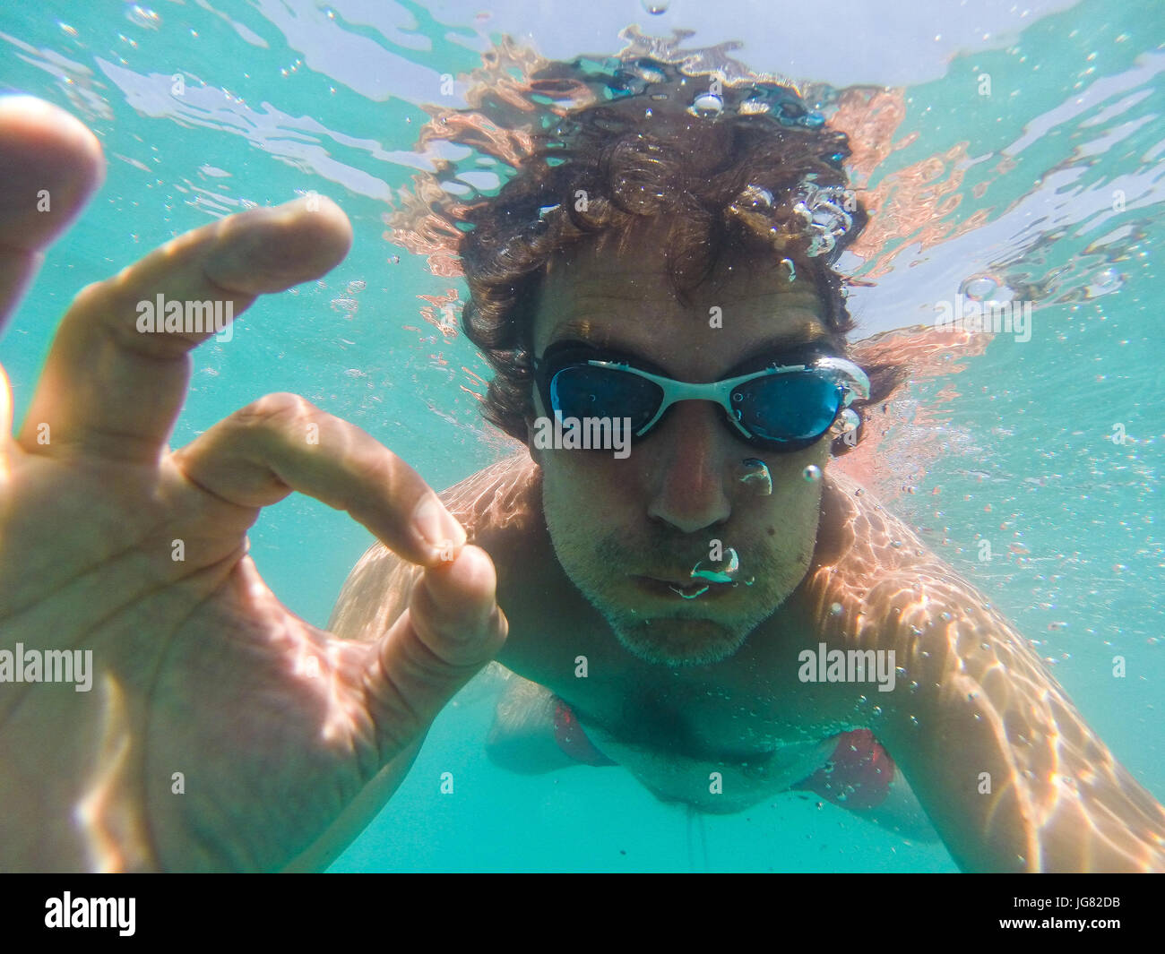 Underwater view of man swimming in the sea Stock Photo - Alamy