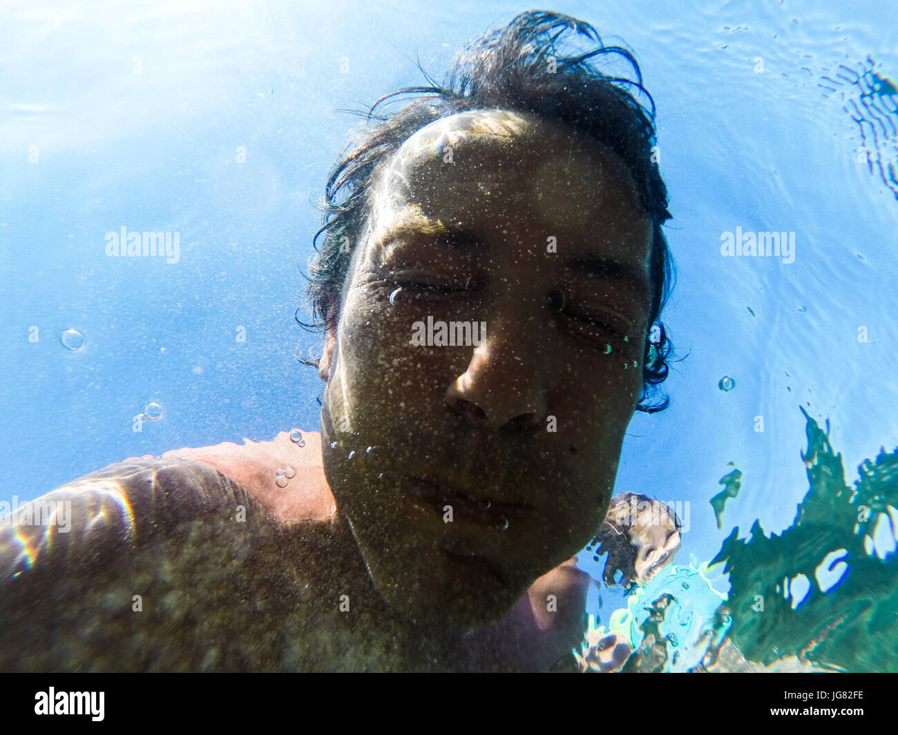 Underwater view of man swimming in the sea Stock Photo - Alamy