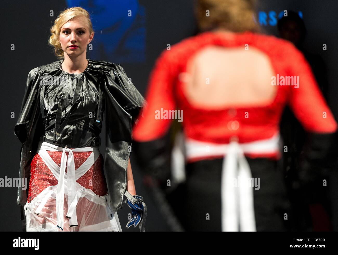 Berlin, Germany. 3rd July, 2017. A model wears clothes designed by ...