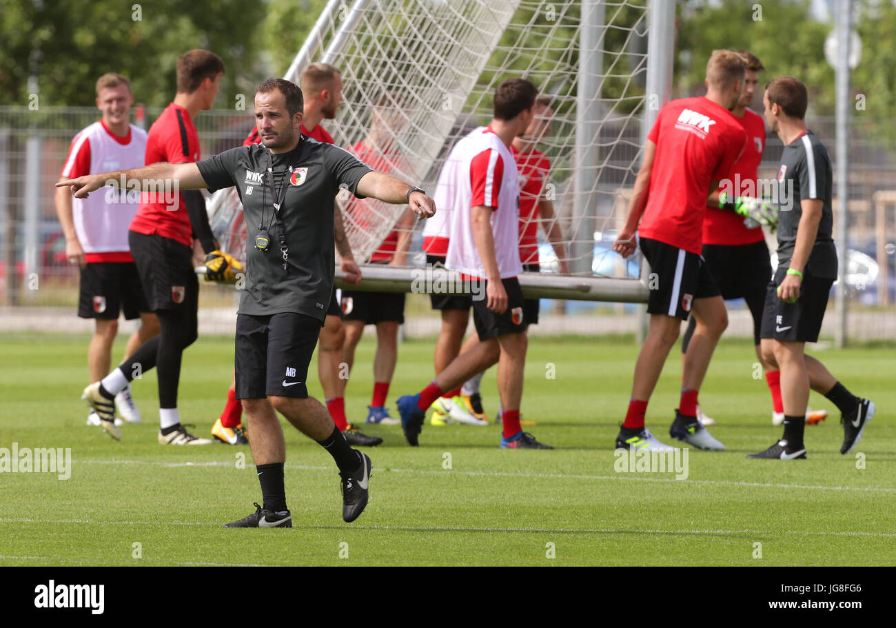 Coach Manuel Baum walks on the pitch in front of his players during the ...