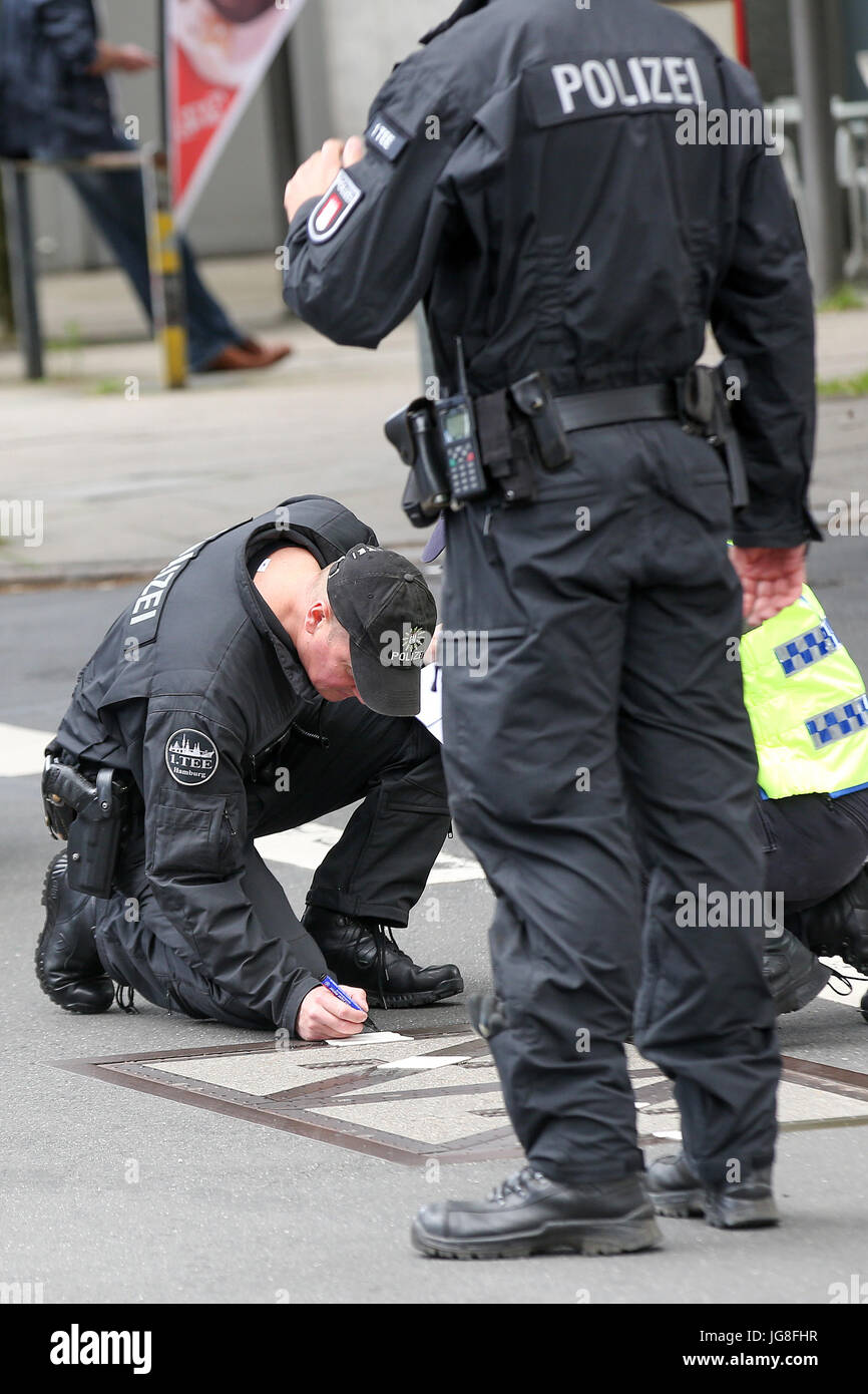 Police officers seal a trunking lid before the G20 summit in Hamburg ...