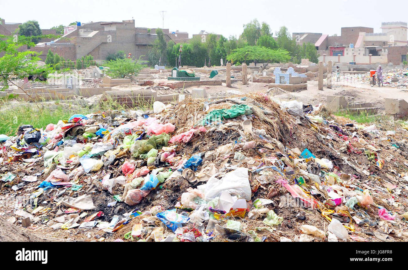 The hectic view of Abu Bakar graveyard by garbage dumped showing ...