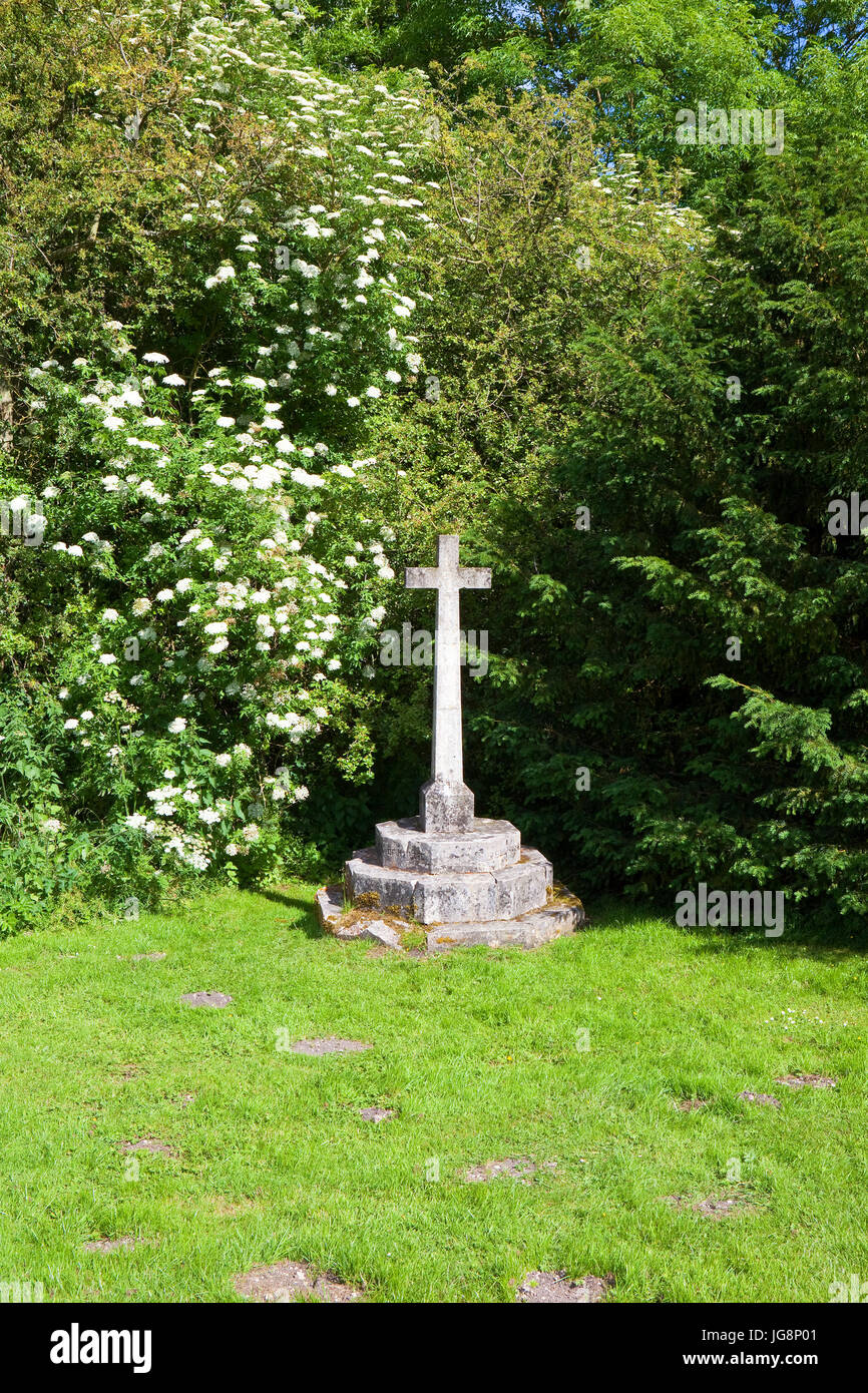 The stone cross at Saint Martins church in the deserted medieval ...