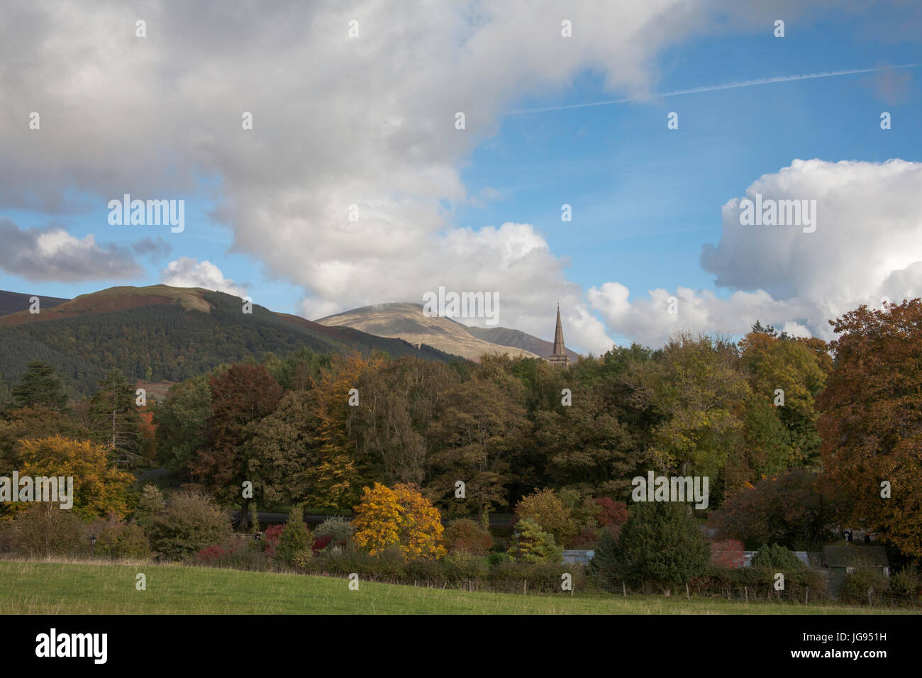 Cloud streaming across the summit of Blencathra with the spire of the ...