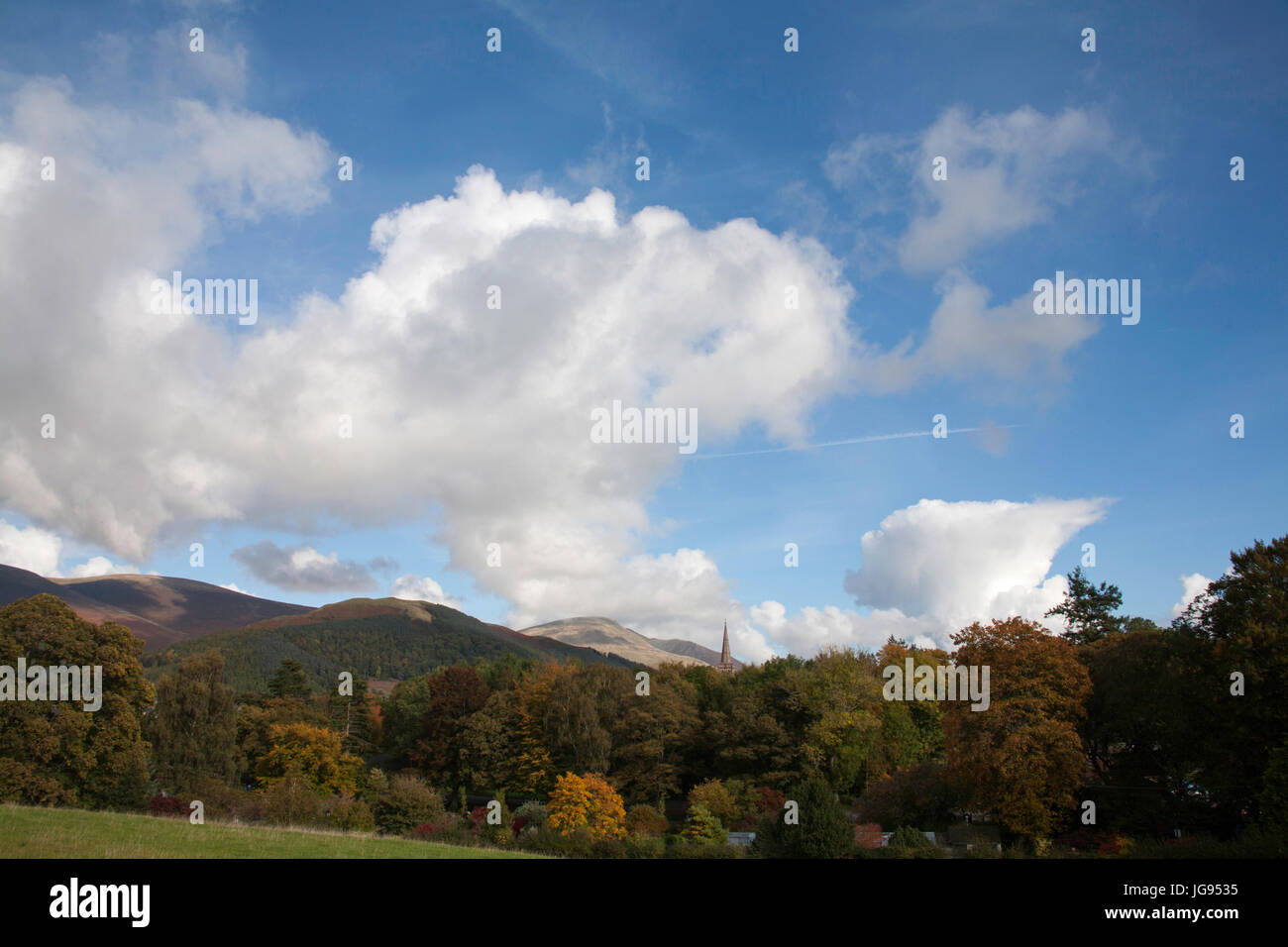 Cloud streaming across the summit of Blencathra with the spire of the ...