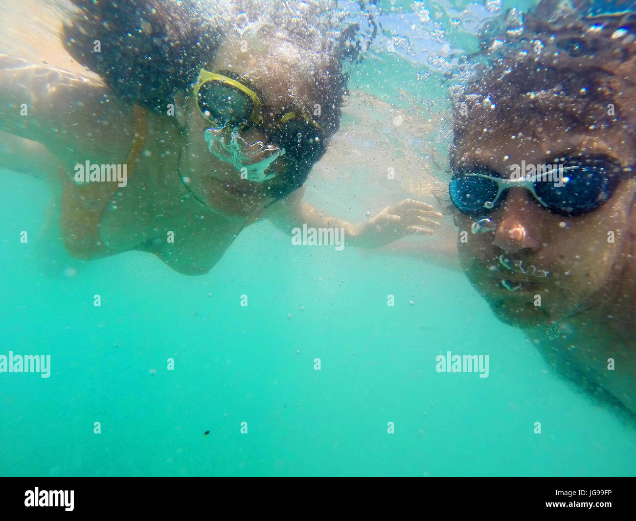 Underwater photo of a young couple diving in the sea Stock Photo - Alamy