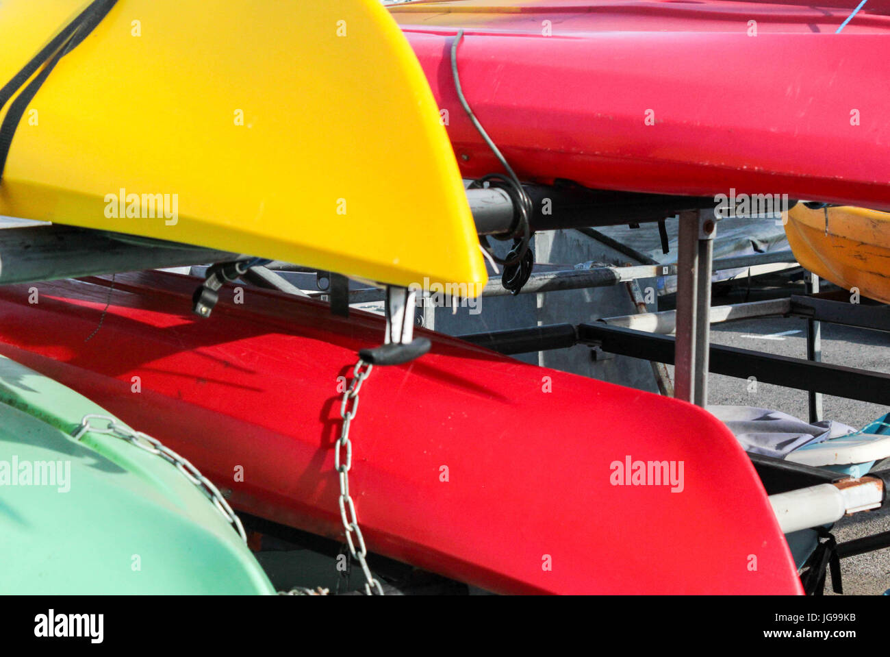 Colourful Canoes Stacked in a Harbour Stock Photo - Alamy