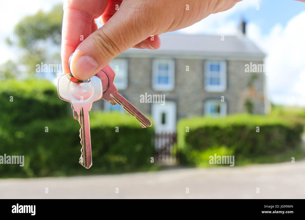 A House Key Held In Front Of A House High Resolution Stock Photography ...