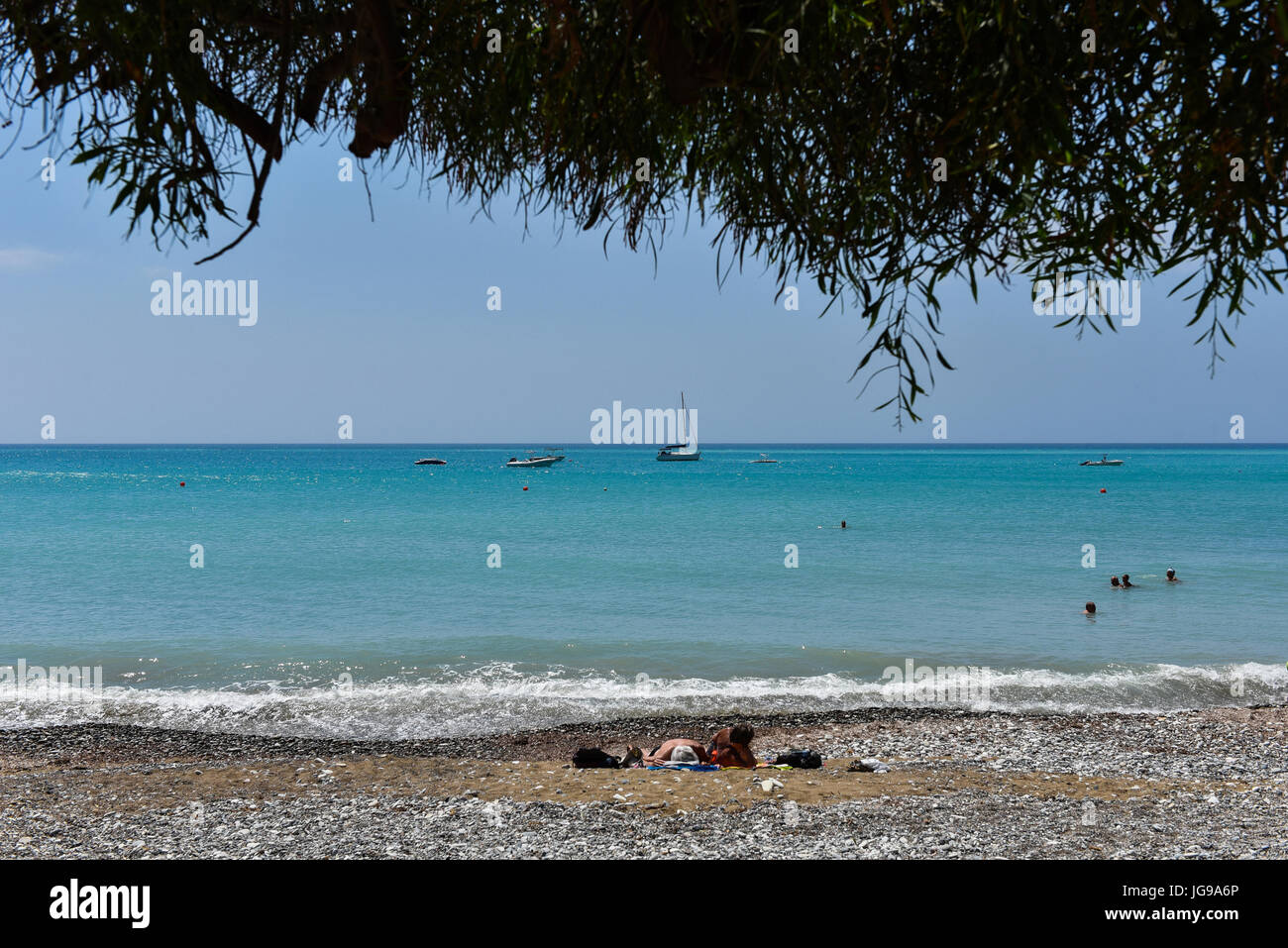 PISSOURI BAY, CYPRUS - JUNE 10, 2017: Tourists relaxing, sunbathing and ...