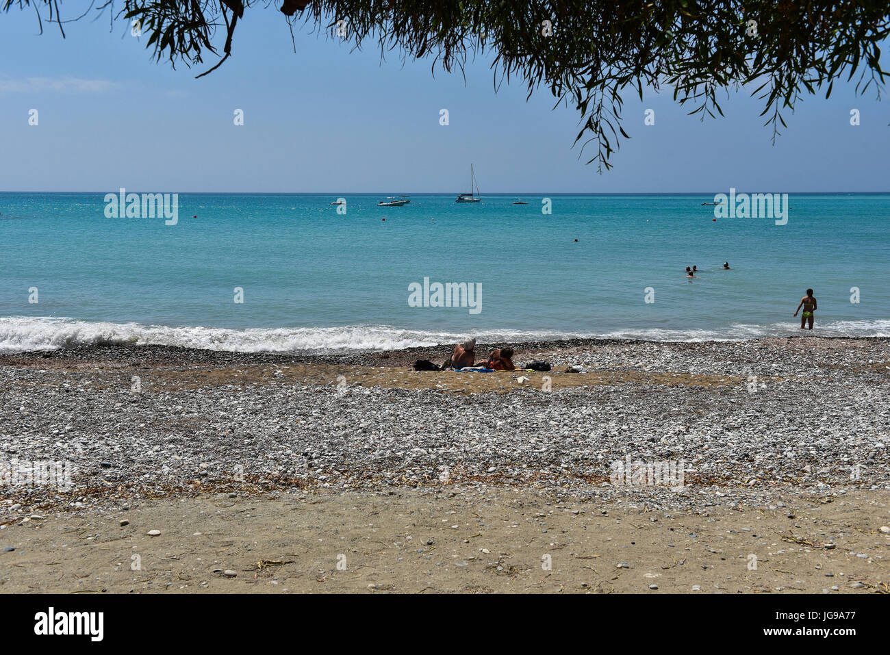 PISSOURI BAY, CYPRUS - JUNE 10, 2017: Tourists relaxing, sunbathing and ...