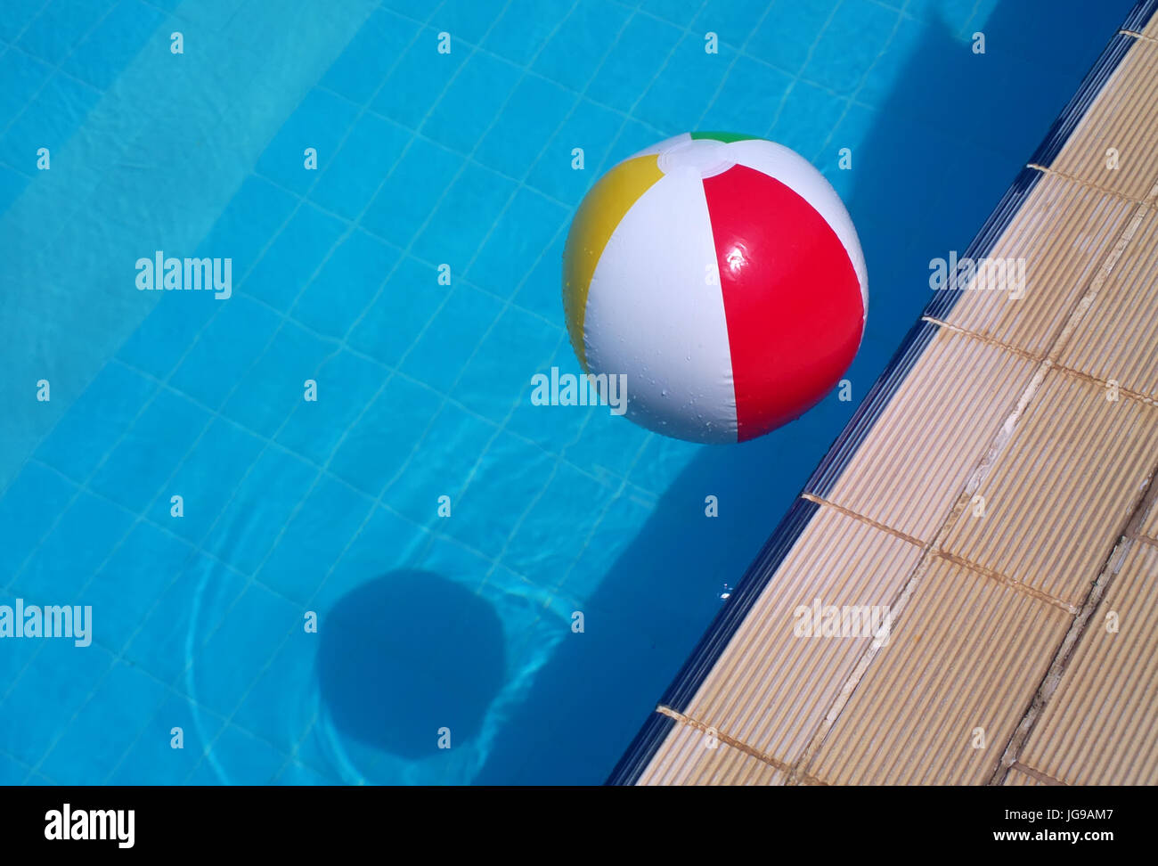 Colorful ball floating on a swimming pool Stock Photo - Alamy