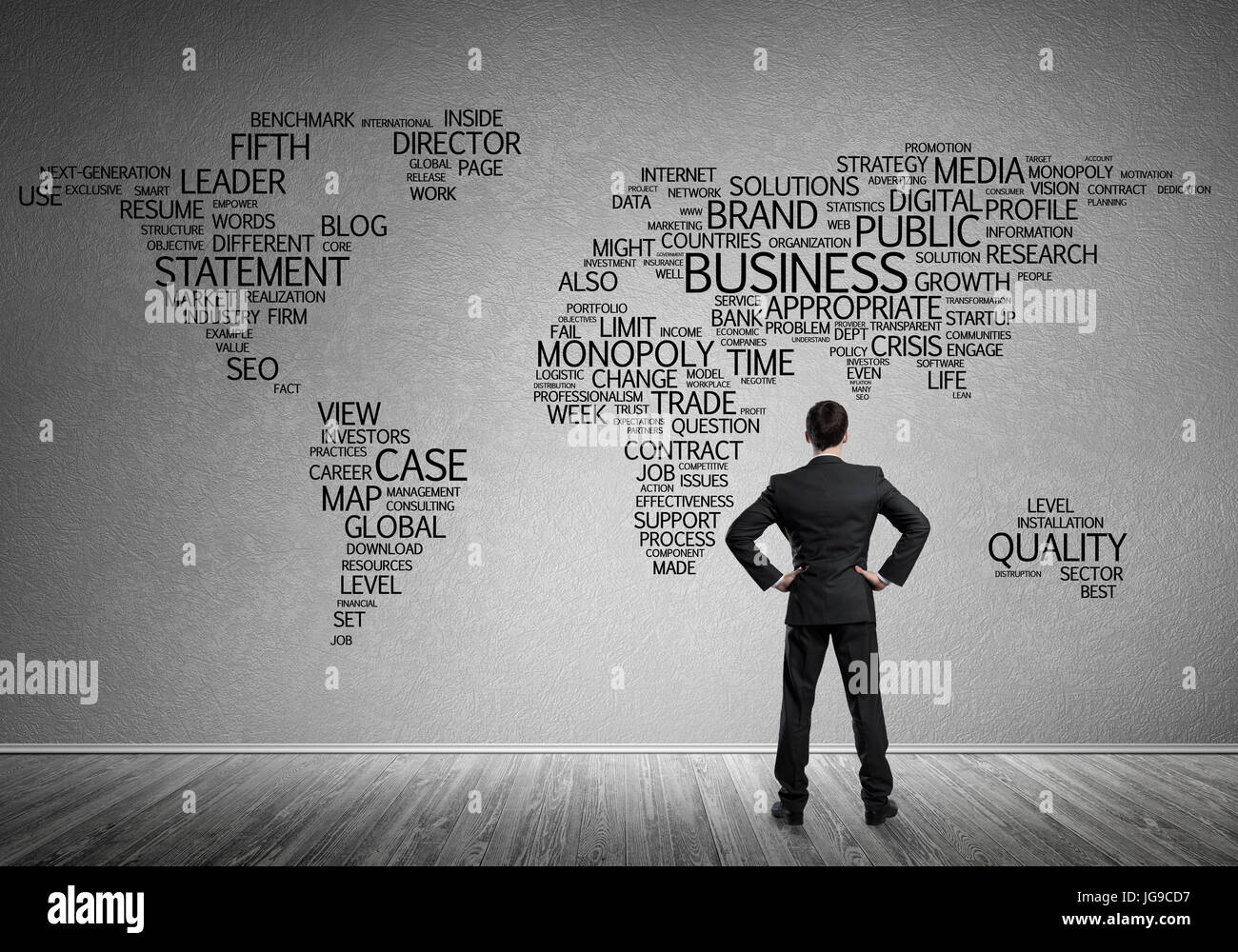Businessman standing with back and looking at world map on concrete ...