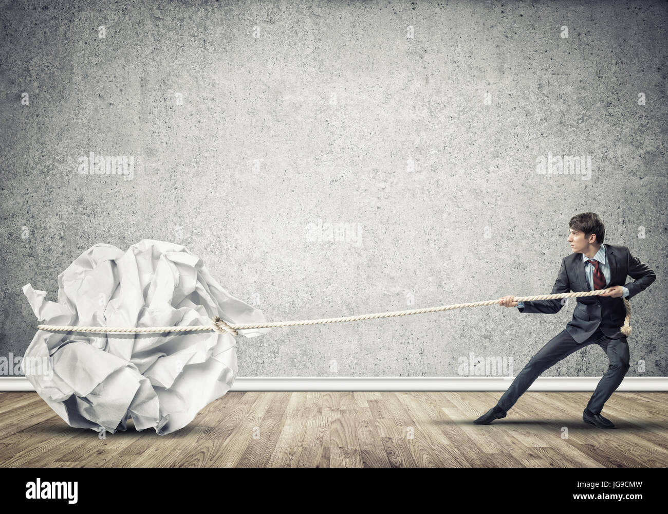 Young man making huge paper ball move Stock Photo - Alamy