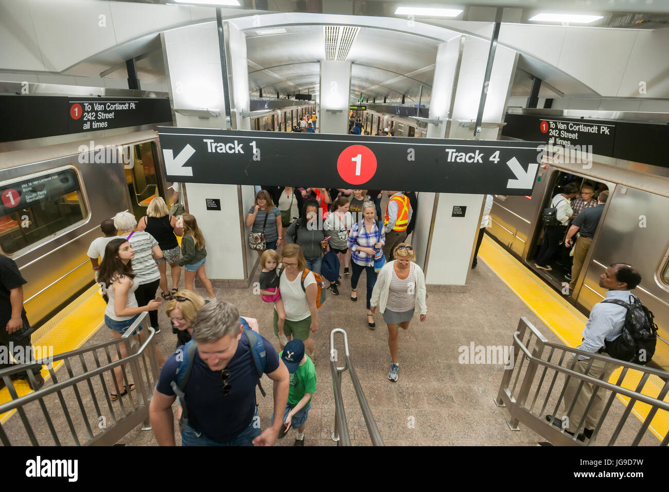 Passengers arrive and depart the newly restored South Ferry subway ...