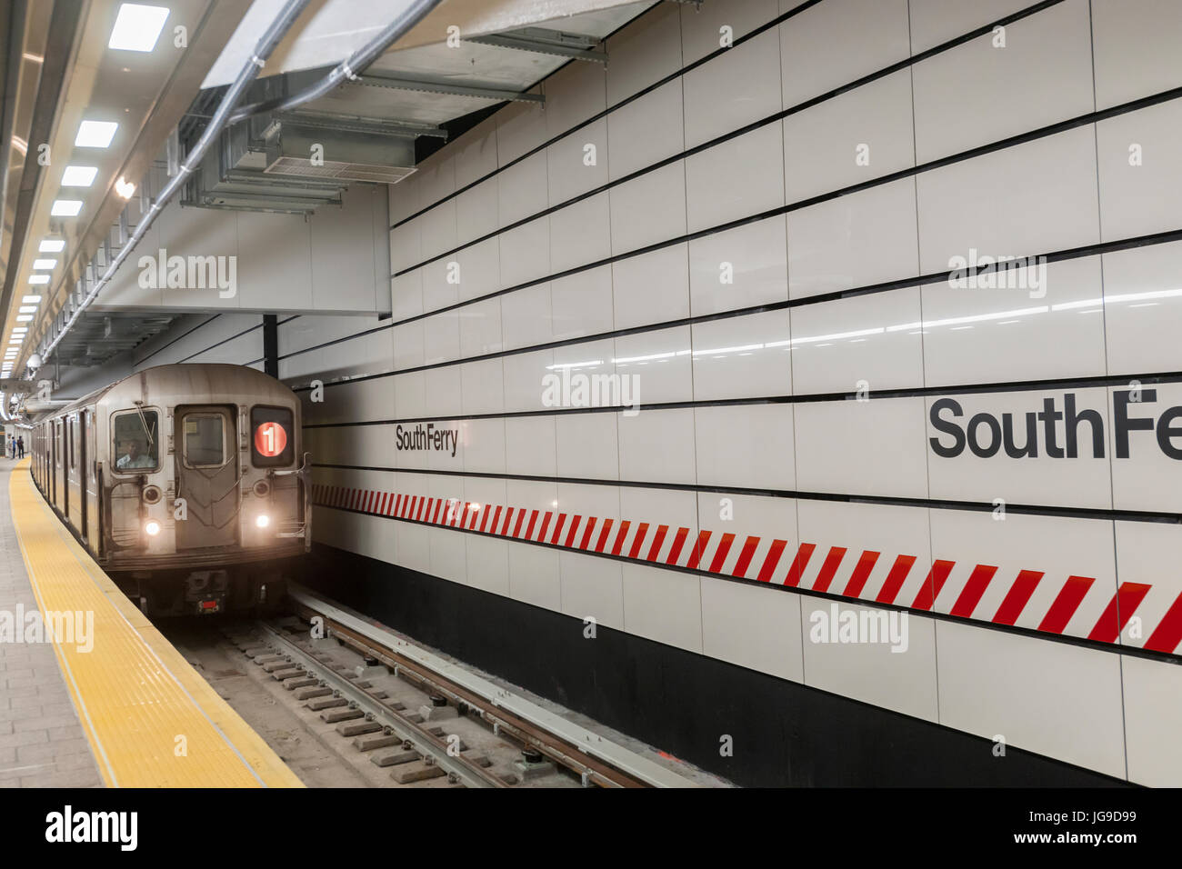 A Number One train arrives in the newly restored South Ferry subway ...