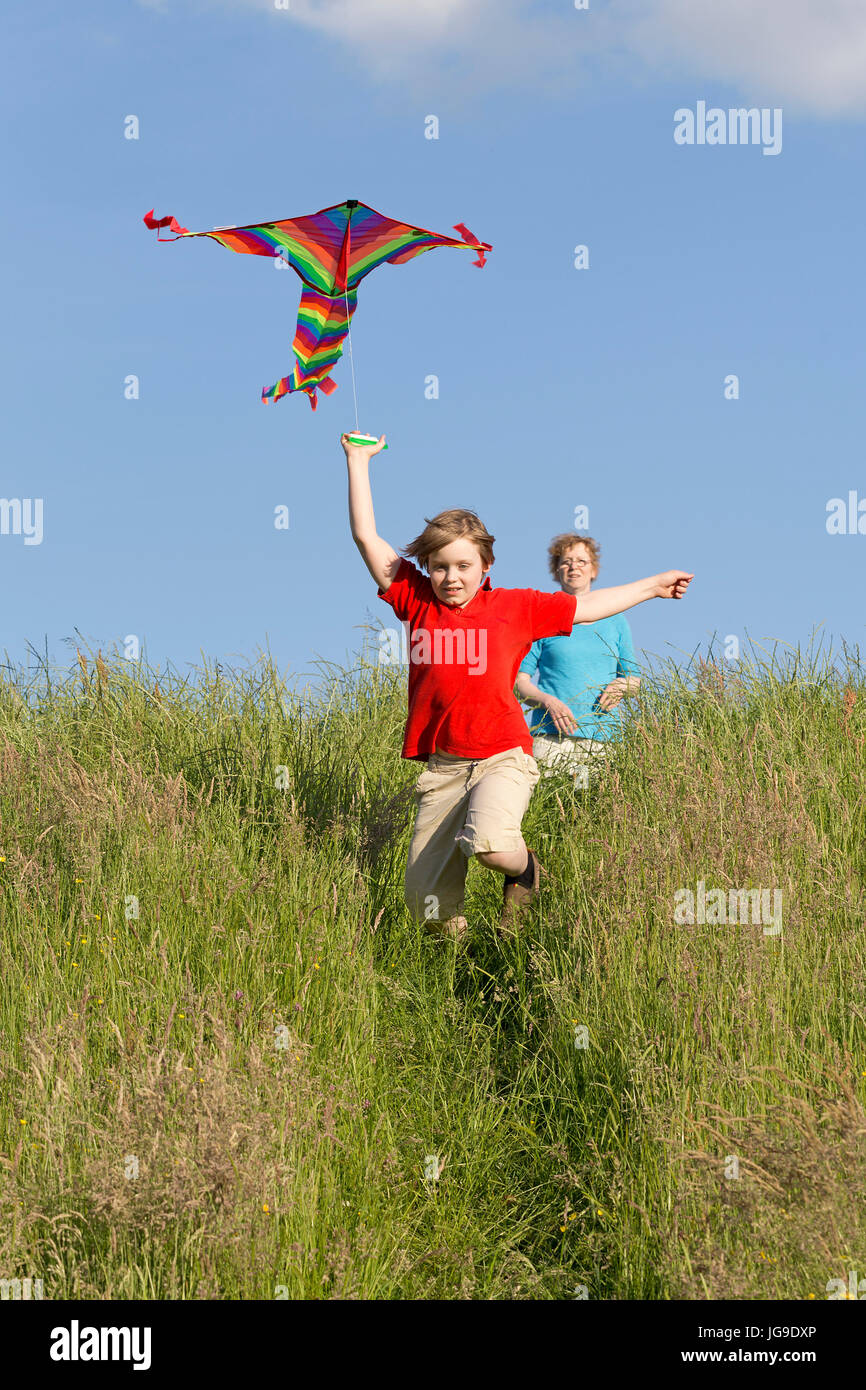 Child flying kite hi-res stock photography and images - Alamy