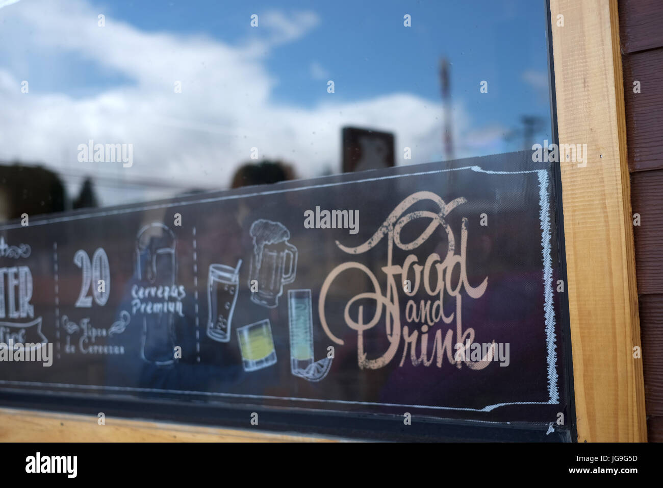 Restaurant advert in a window with reflection Stock Photo - Alamy