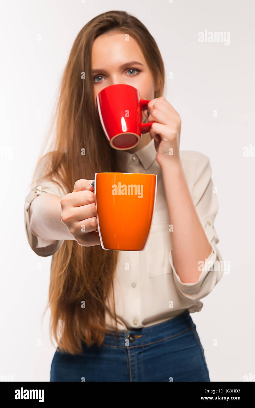 Young beautiful smiling girl holding a cup Stock Photo - Alamy