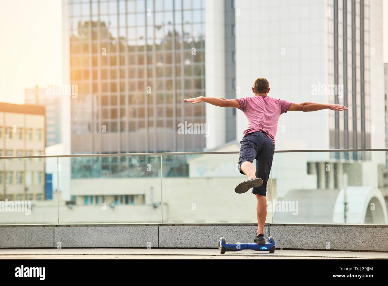 Man on hoverboard, back view Stock Photo - Alamy