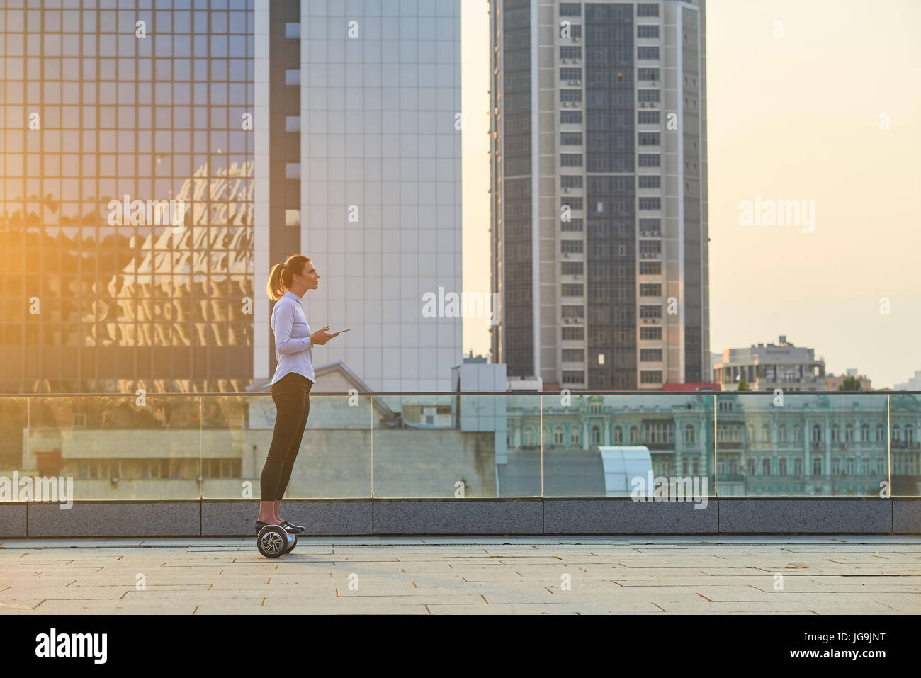 Woman riding hoverboard, side view Stock Photo - Alamy