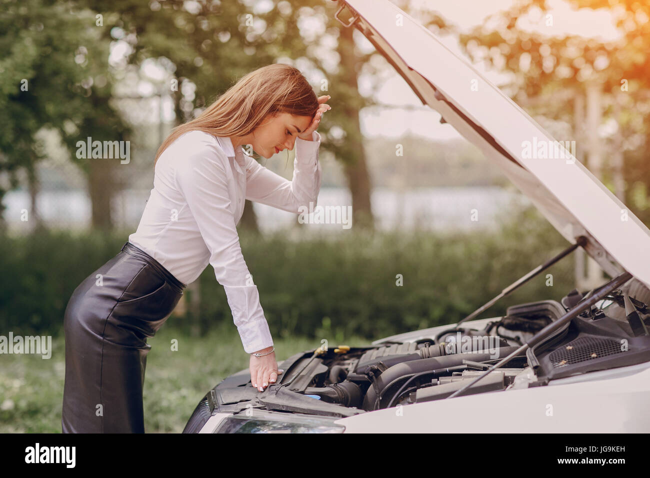 two girls on the road trying to fix their car Stock Photo - Alamy