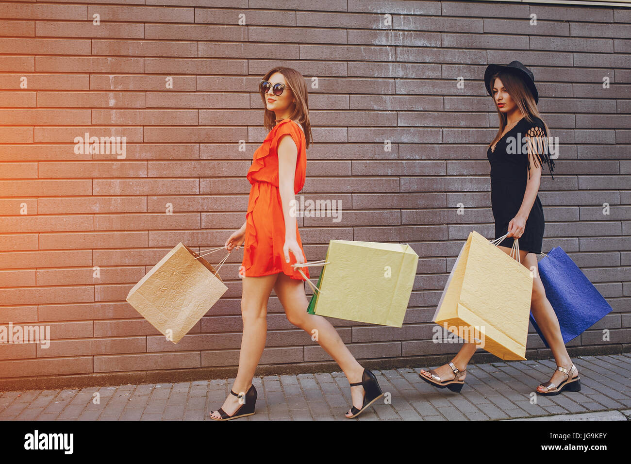 two beautiful young women walk to the shops and make purchases Stock ...