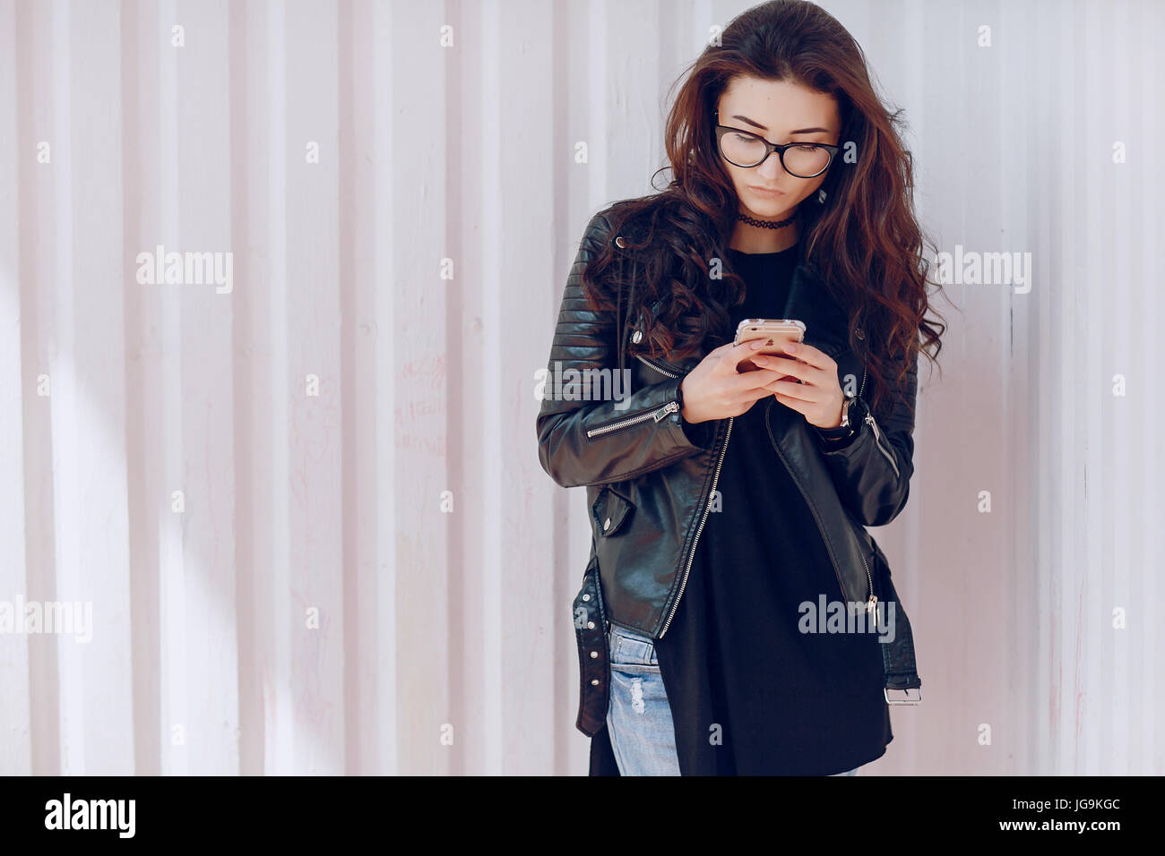 stylish young model walk in the street and pose for a photo on a Sunny ...