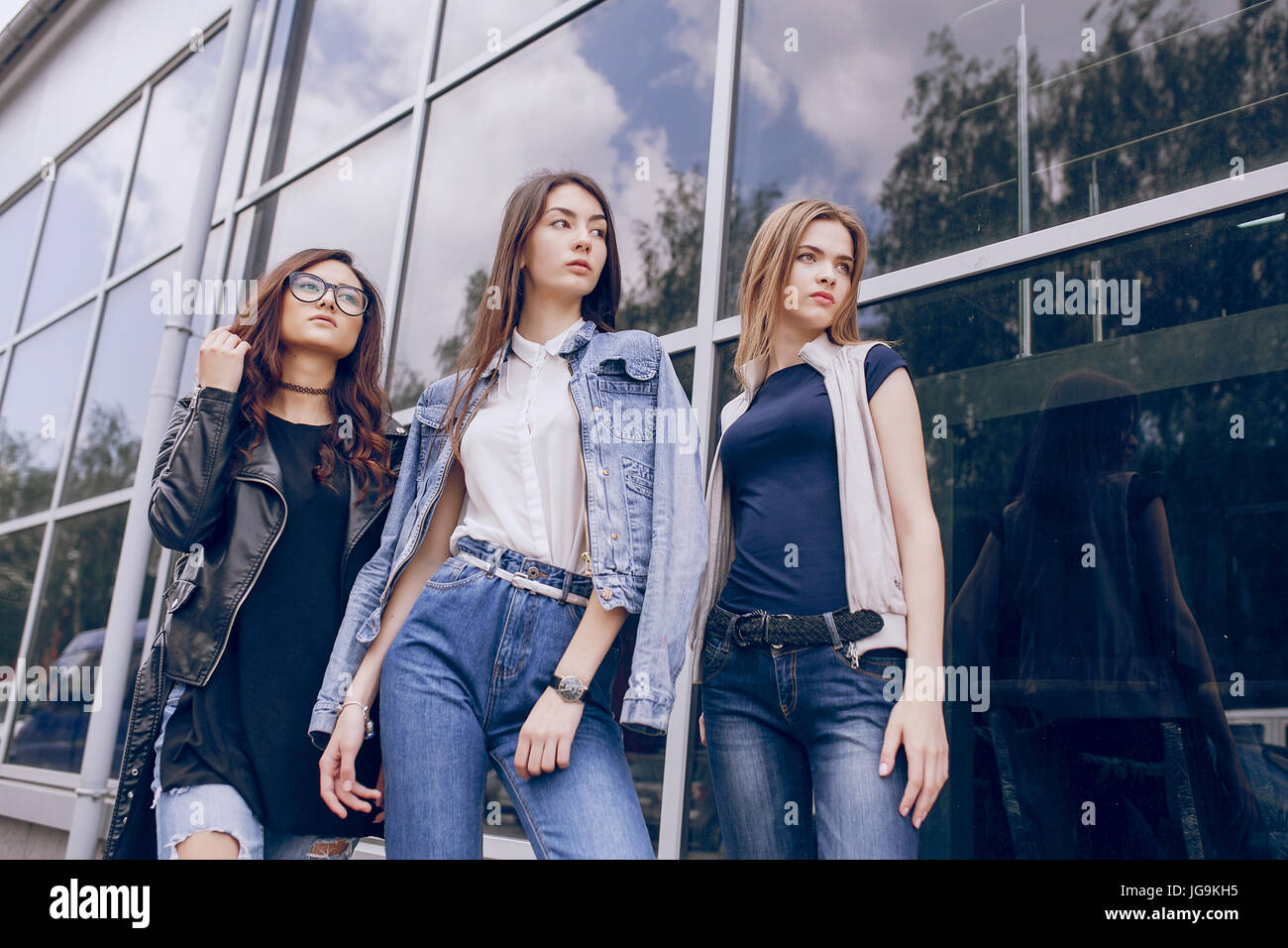 stylish young model walk in the street and pose for a photo on a Sunny ...