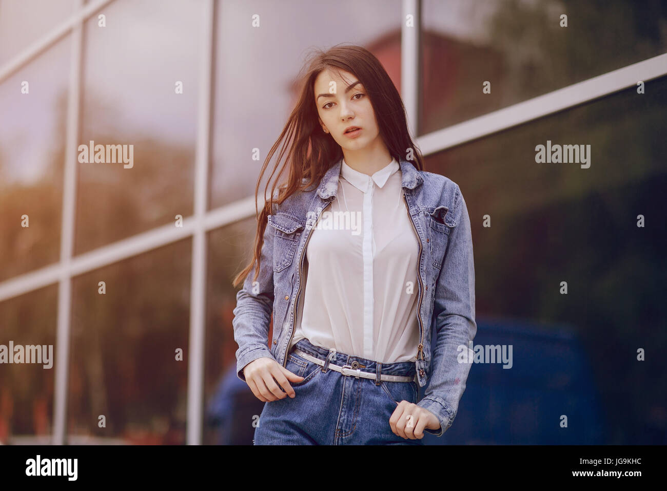stylish young model walk in the street and pose for a photo on a Sunny ...