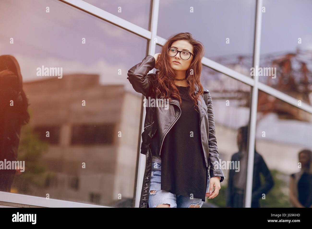 stylish young model walk in the street and pose for a photo on a Sunny ...