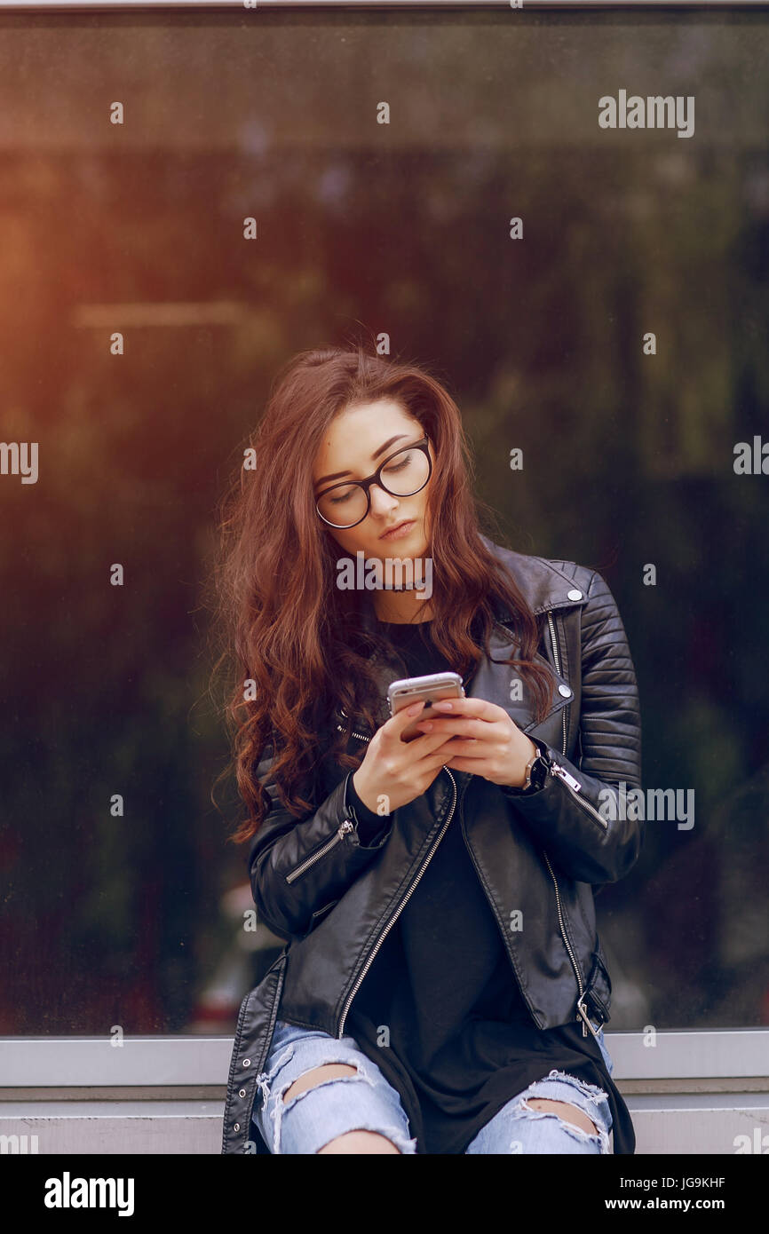 stylish young model walk in the street and pose for a photo on a Sunny ...