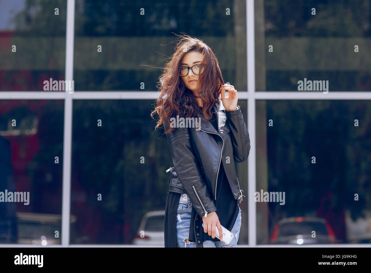 stylish young model walk in the street and pose for a photo on a Sunny ...