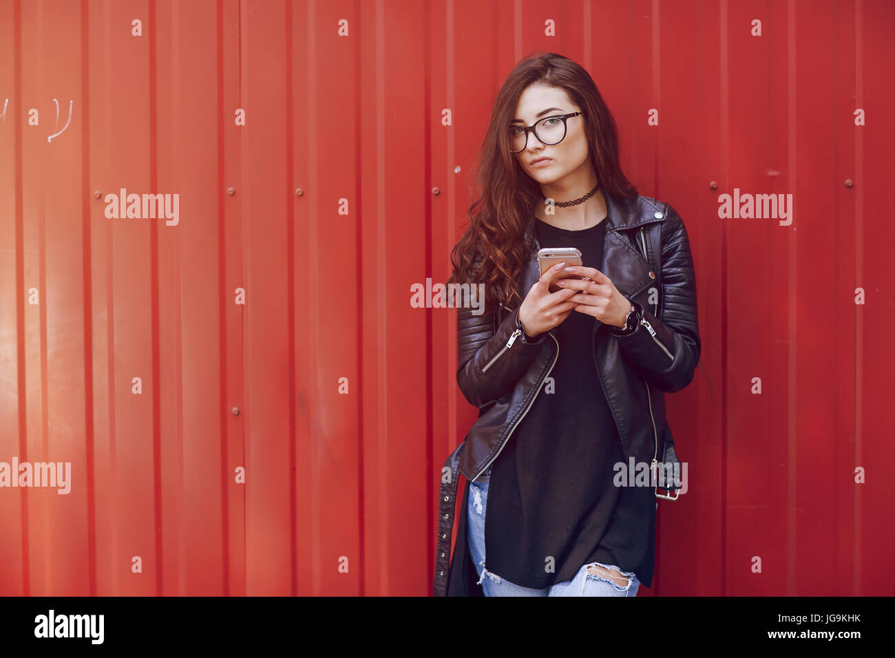 stylish young model walk in the street and pose for a photo on a Sunny ...