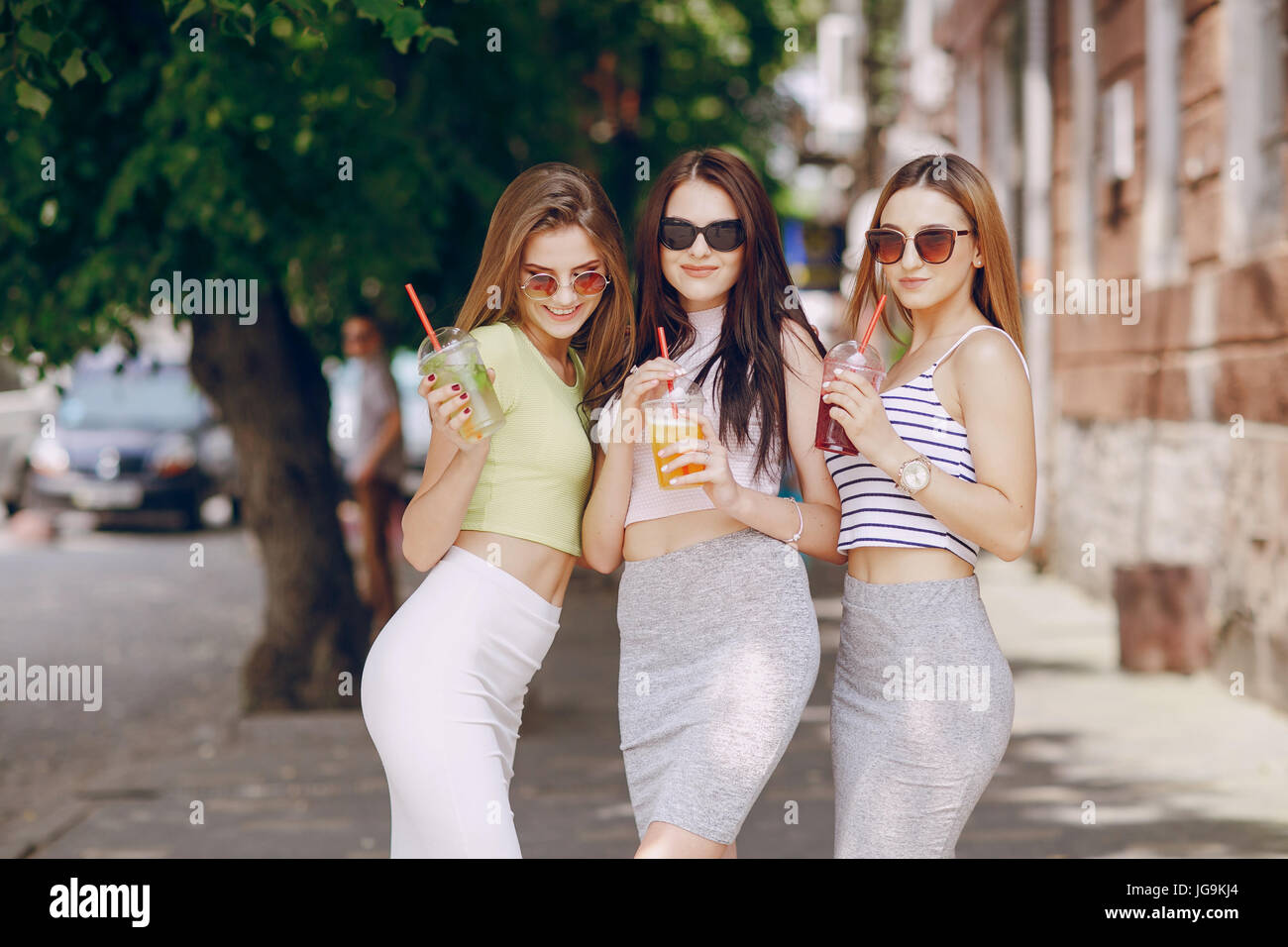 three young models are walking around the city on a warm summer day ...