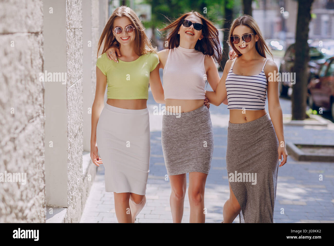three beautiful girls walking around the city Stock Photo - Alamy